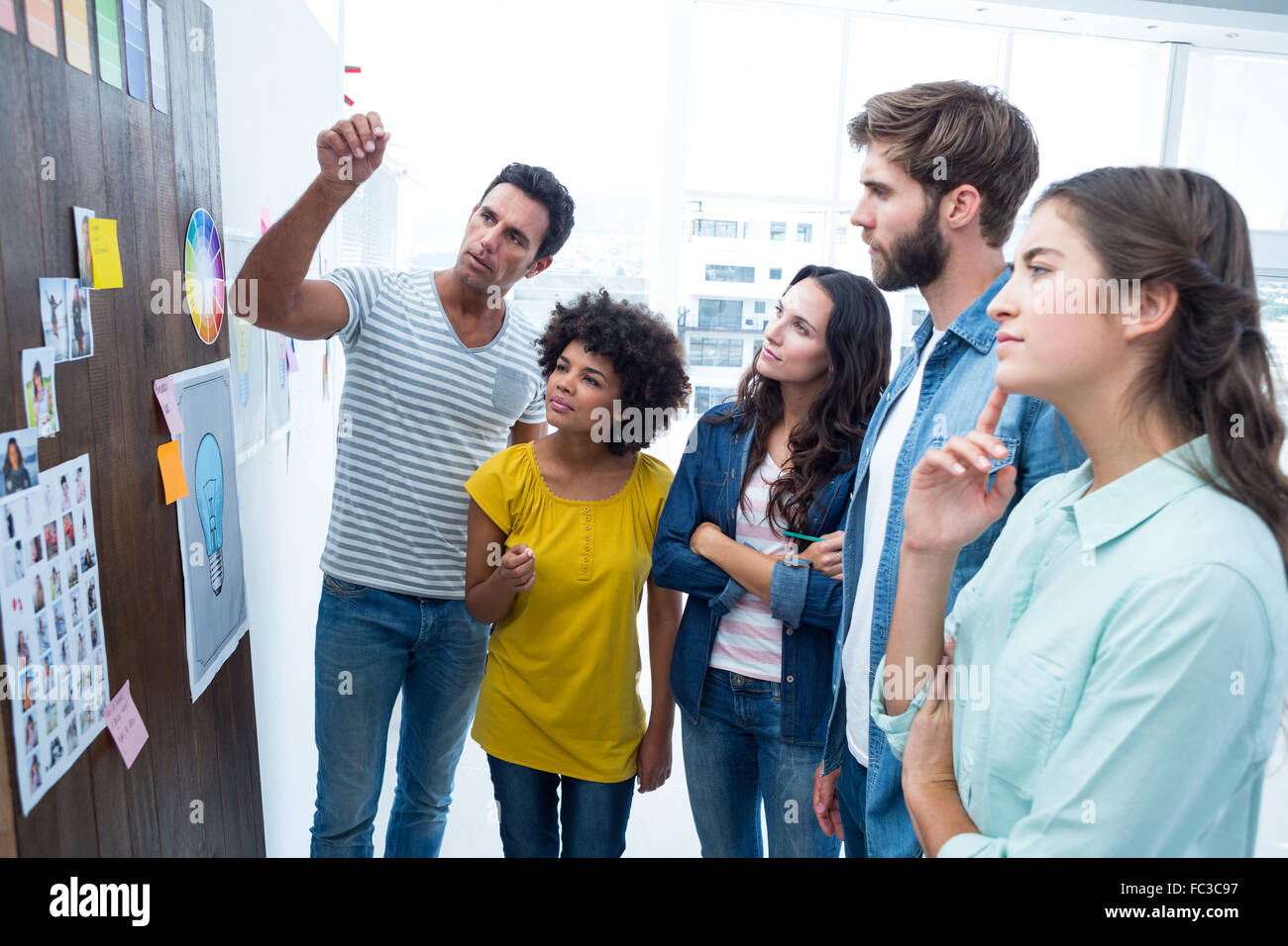 Creative business people at work by blackboard Stock Photo - Alamy