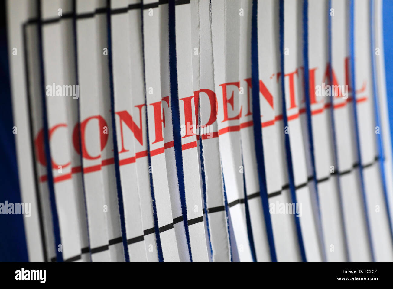 "CONFIDENTIAL" paper through a shredder Stock Photo - Alamy
