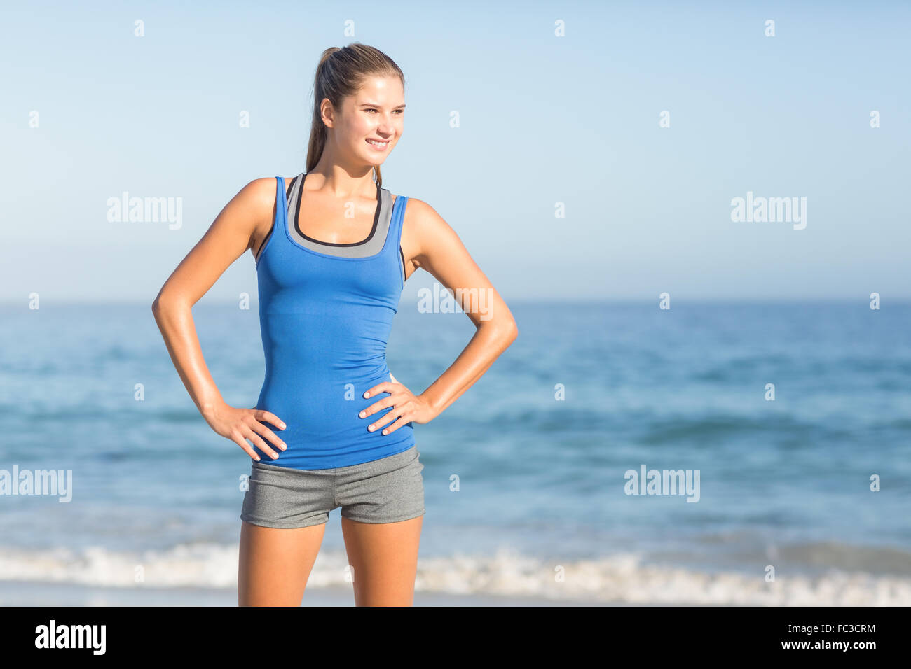 Portrait of beautiful fit woman with hands on hips Stock Photo - Alamy