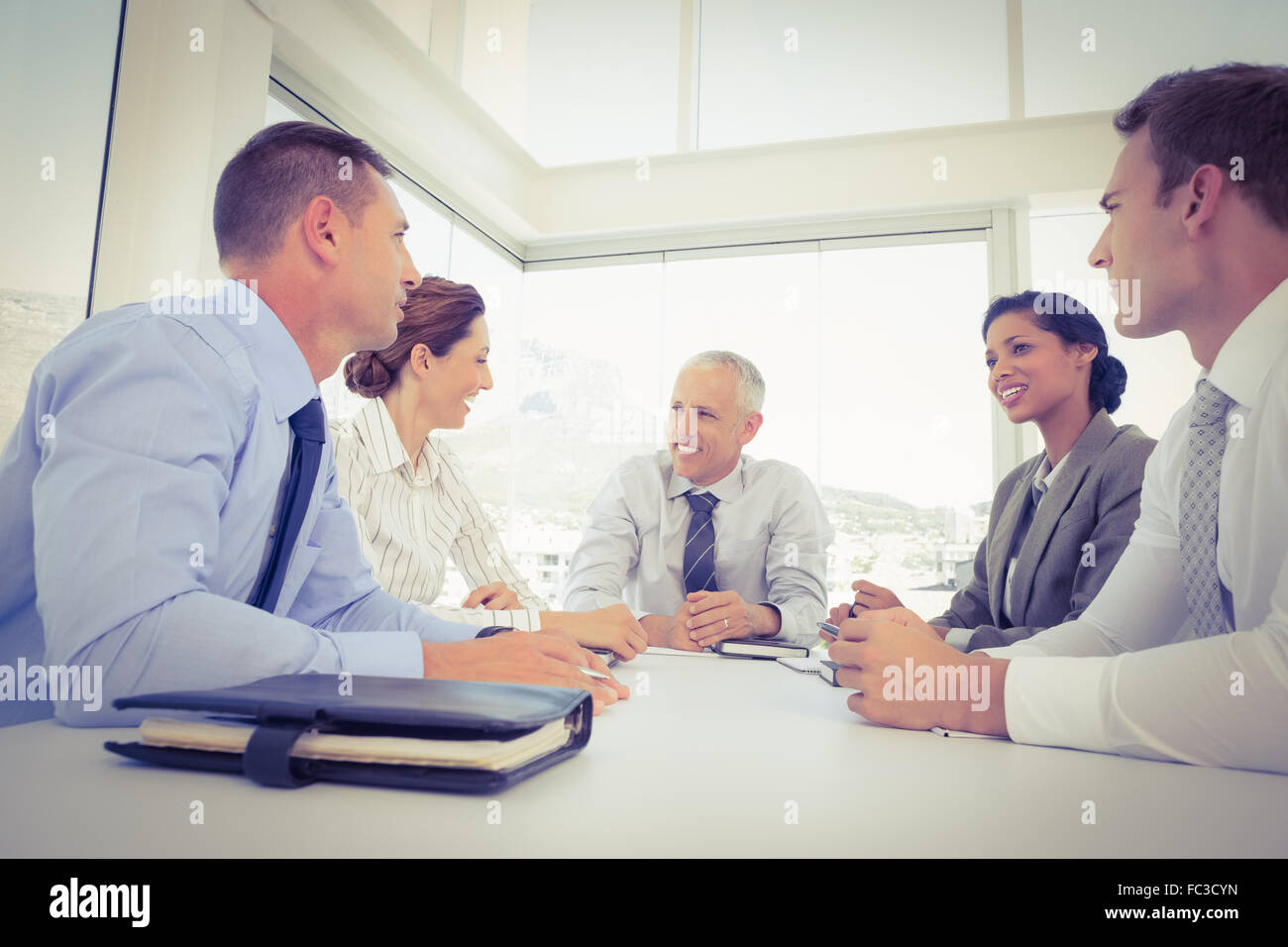 Business team sitting together around the table Stock Photo - Alamy