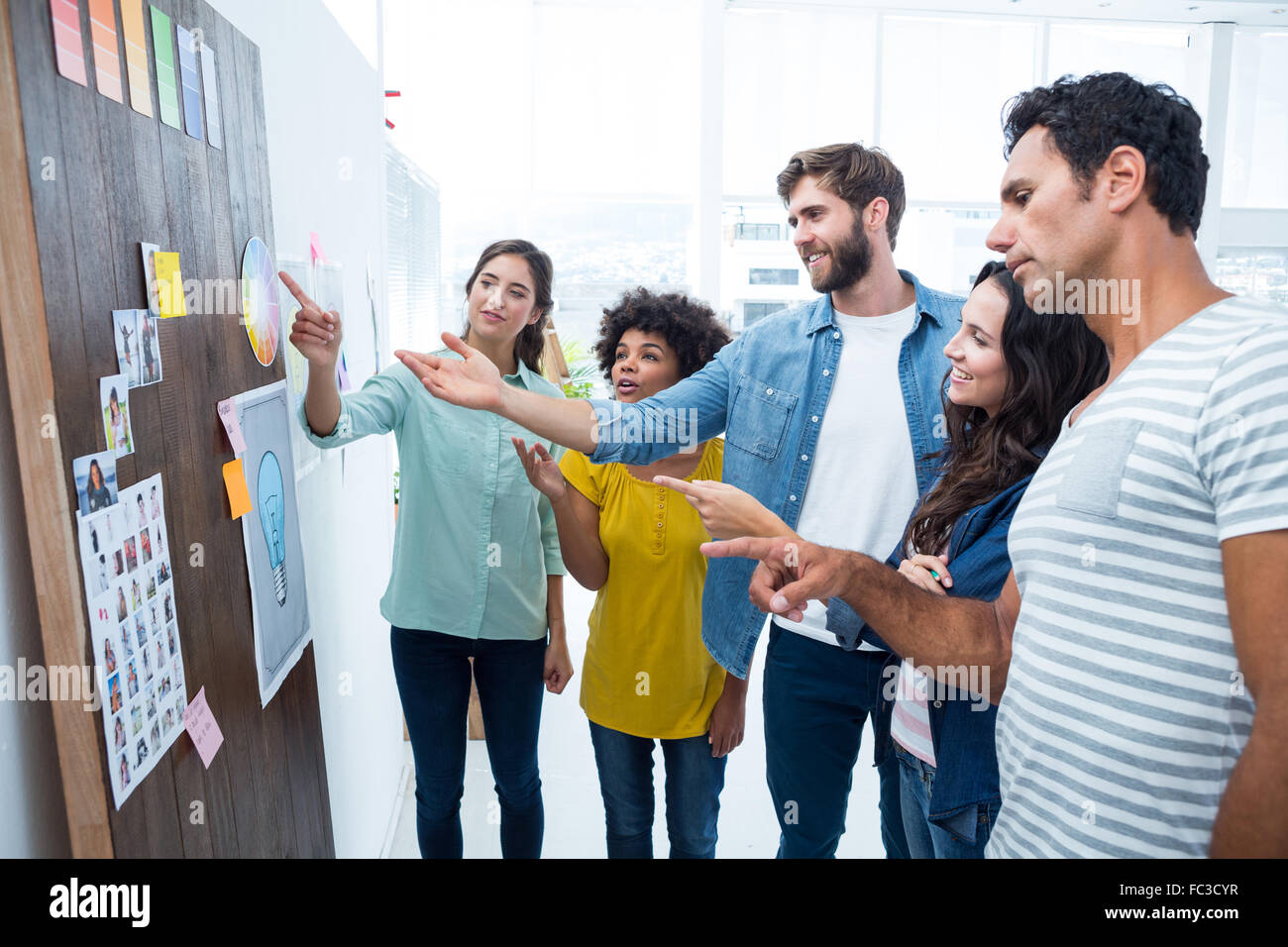 Creative business people at work by blackboard Stock Photo - Alamy