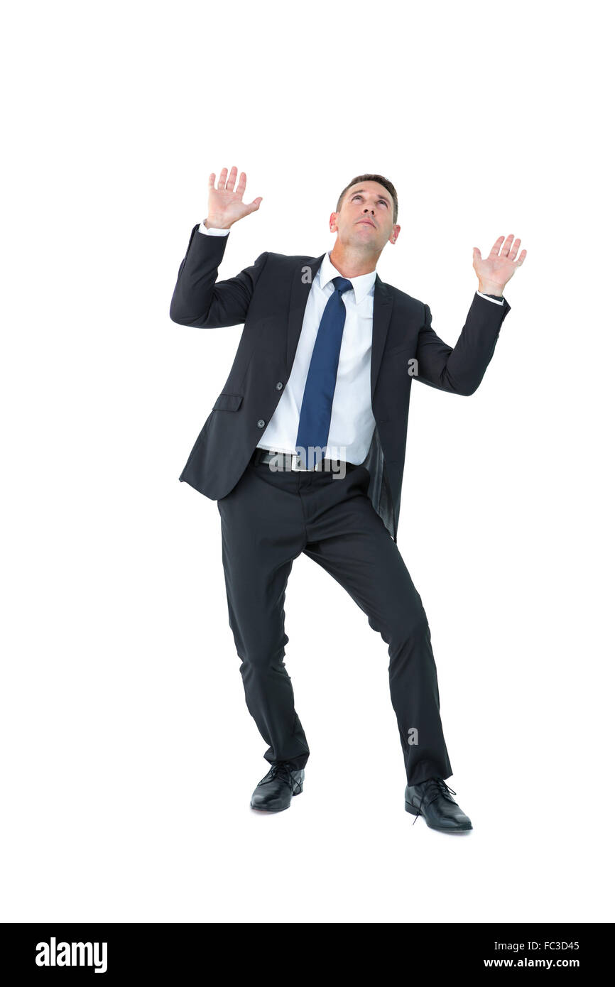 A businessman holding something and looking at top Stock Photo - Alamy