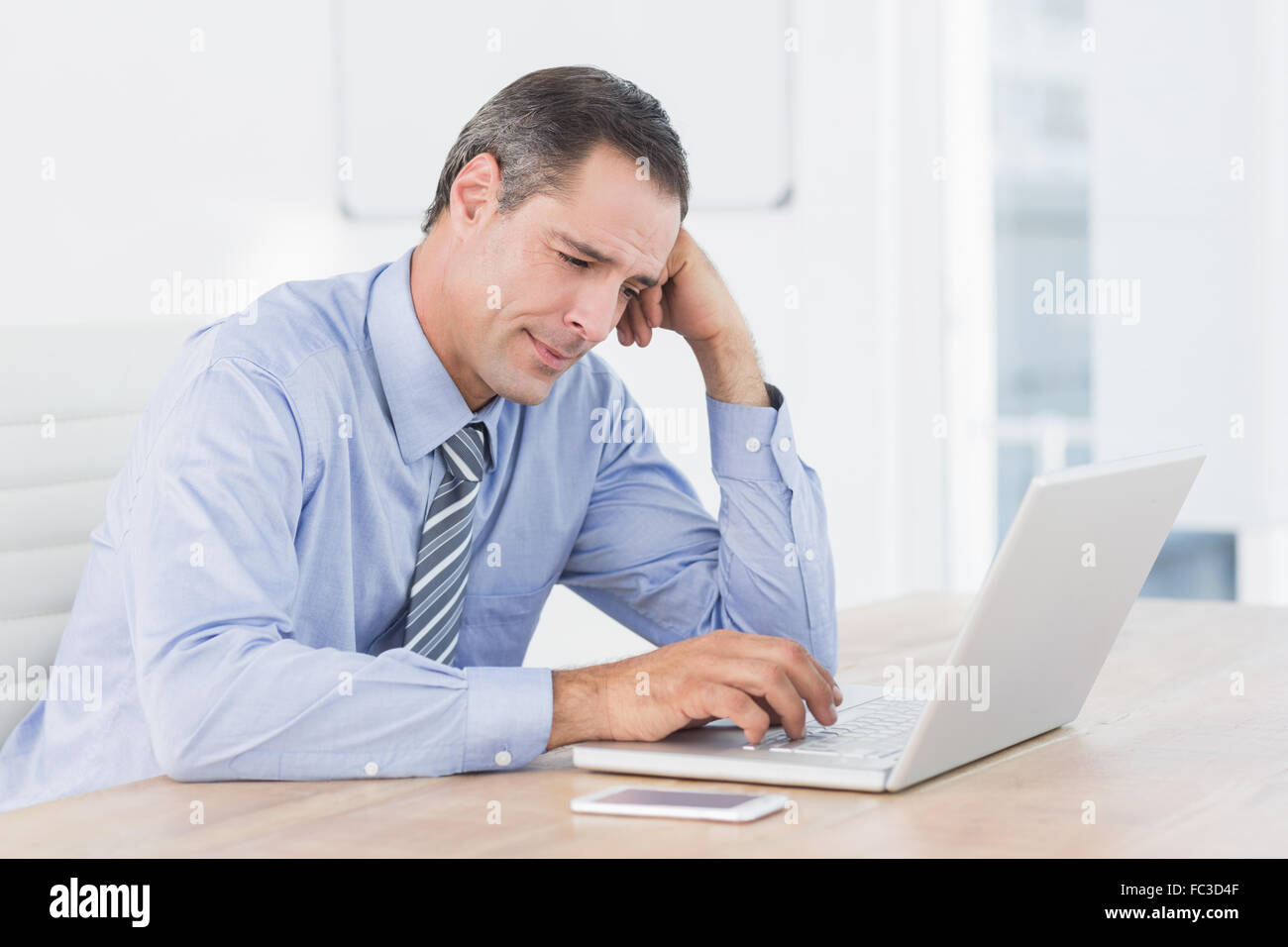 Frustrated businessman working with his computer Stock Photo - Alamy