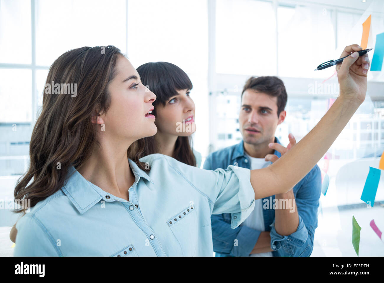 Young creative business people writing photo editor Stock Photo - Alamy