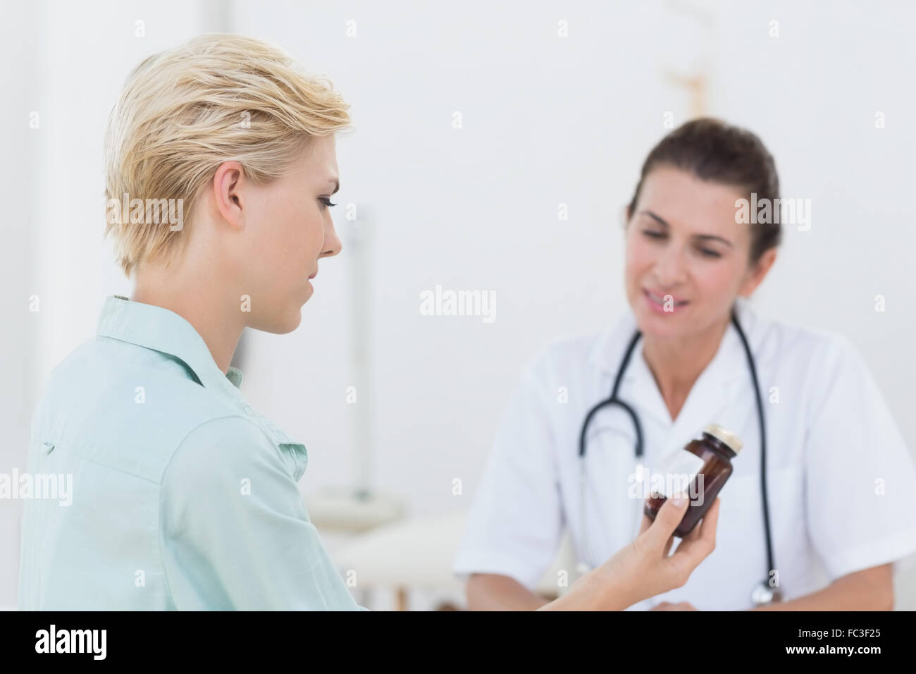 Patient looking at medication with her doctor Stock Photo - Alamy