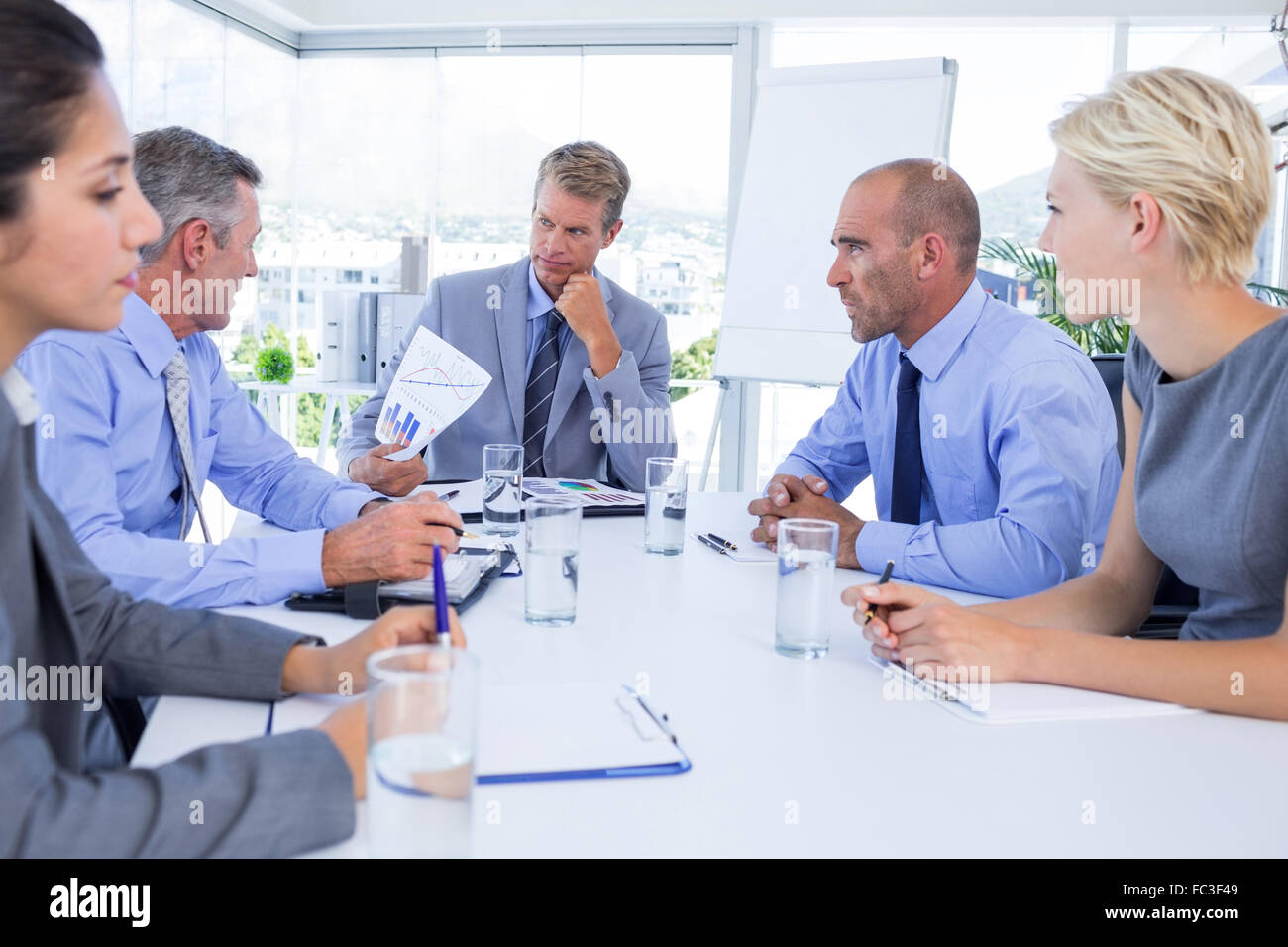 Business people speaking together during meeting Stock Photo - Alamy