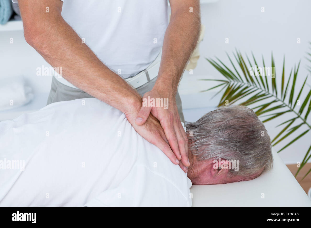 Physiotherapist doing neck massage to his patient Stock Photo - Alamy
