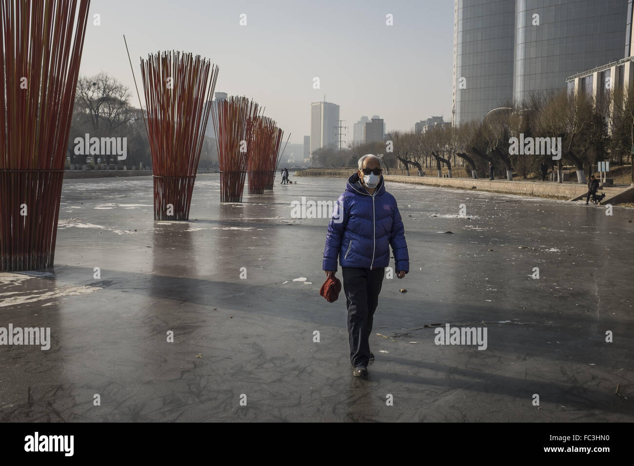 Beijing, China. 19th Jan, 2016. an old man walks on frozen river in ...