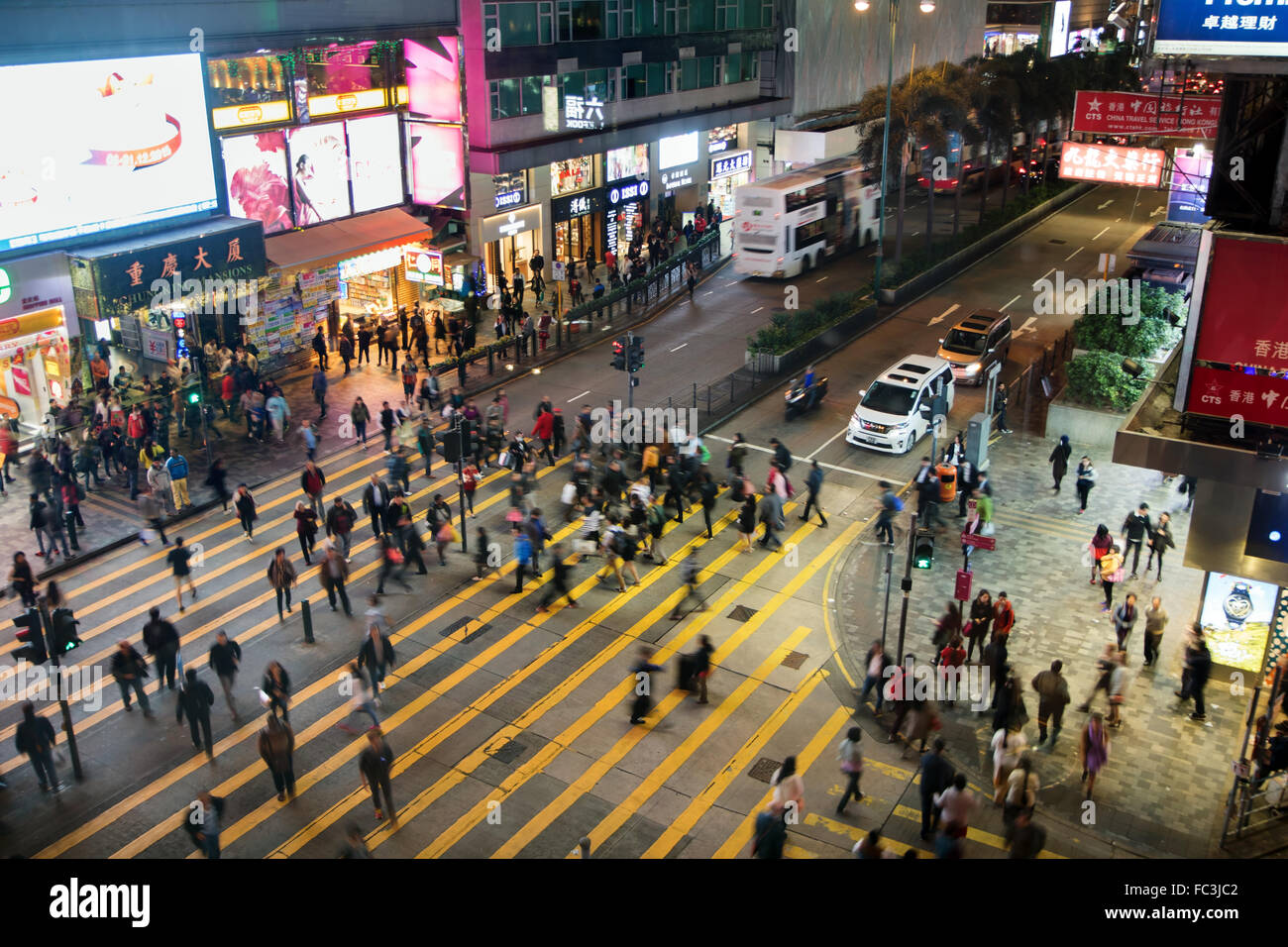 Pedestrians walk on crosswalk in night Kowloon Stock Photo - Alamy