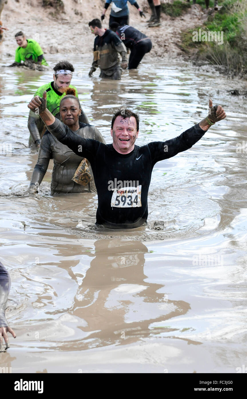 Runners crossing muddy obstacles at obstacle course race, UK Stock ...
