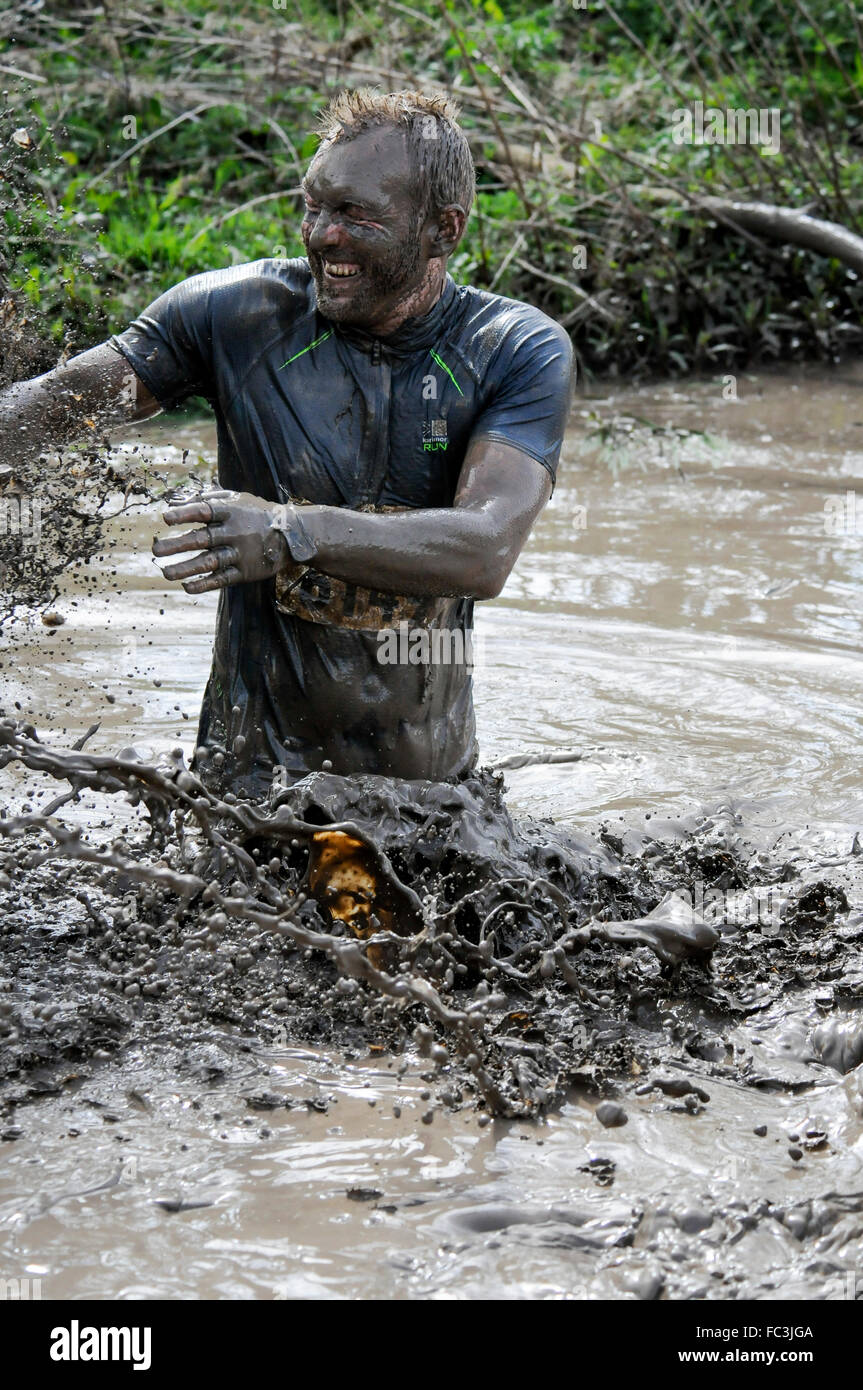 Runners crossing muddy obstacles at obstacle course race, UK Stock ...