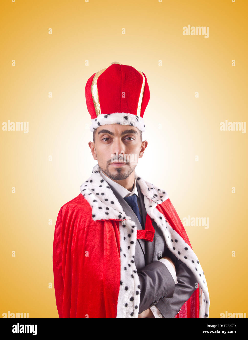 Businessman playing king isolated on white Stock Photo - Alamy