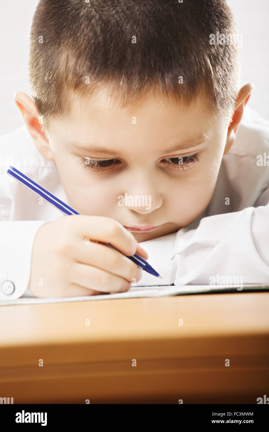 Schoolboy writing closeup Stock Photo - Alamy