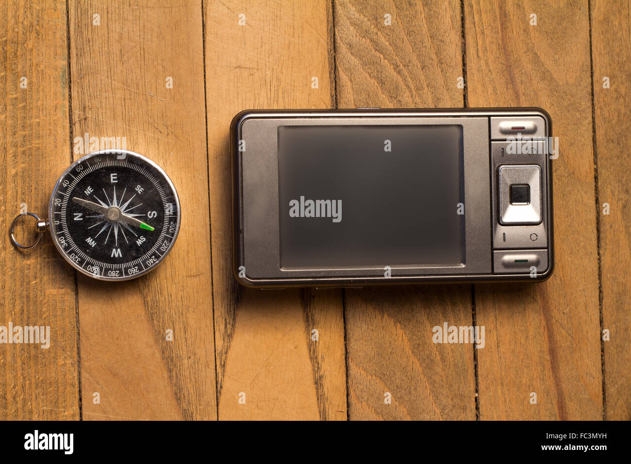 smartphone and compass on wooden background Stock Photo - Alamy
