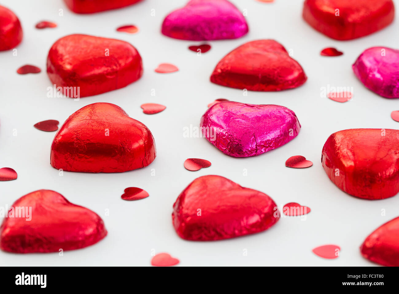 Valentine's Day, heart shaped chocolates and candy on a white, isolated ...