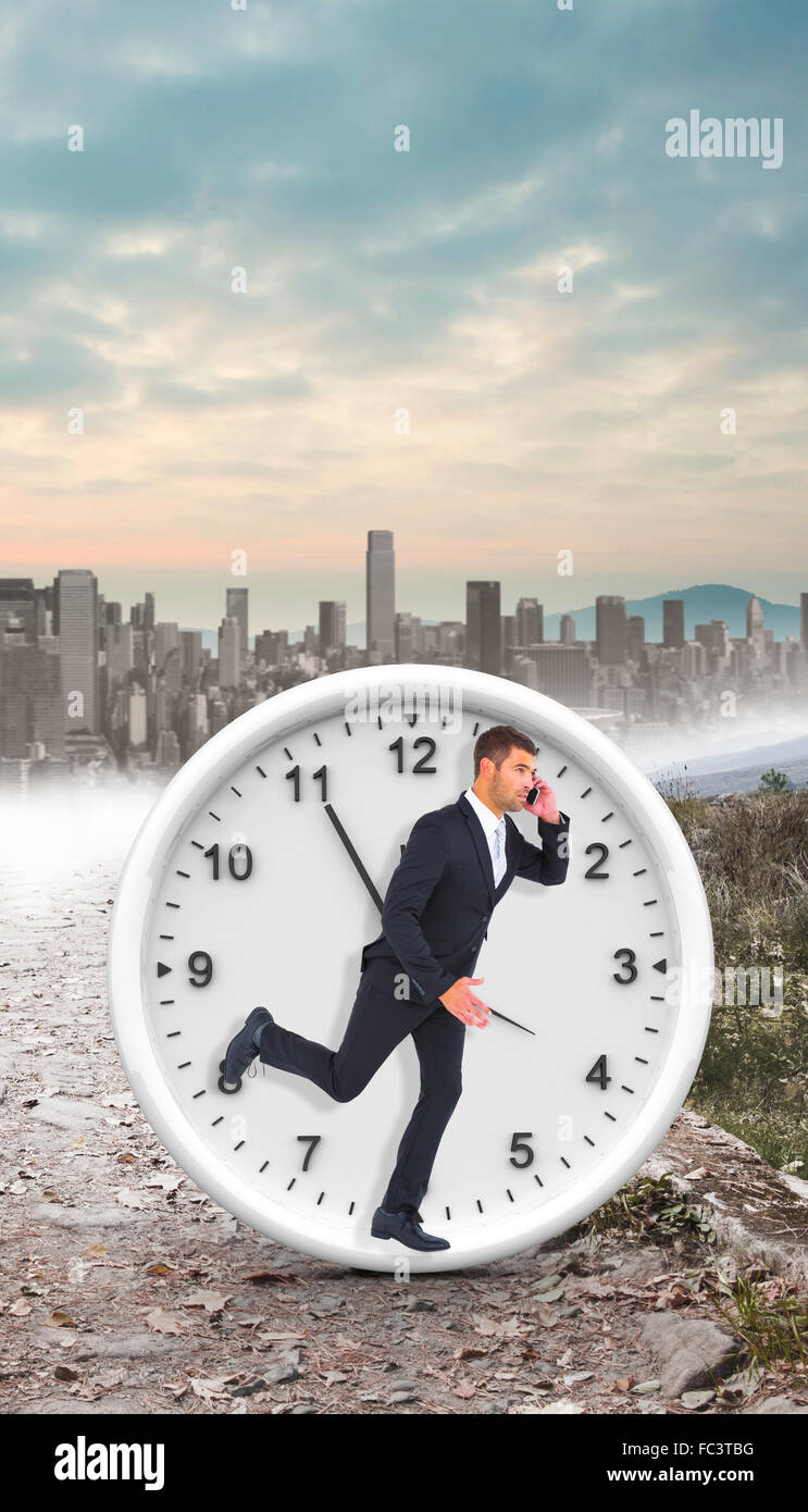 Composite image of businessman running on the phone Stock Photo - Alamy