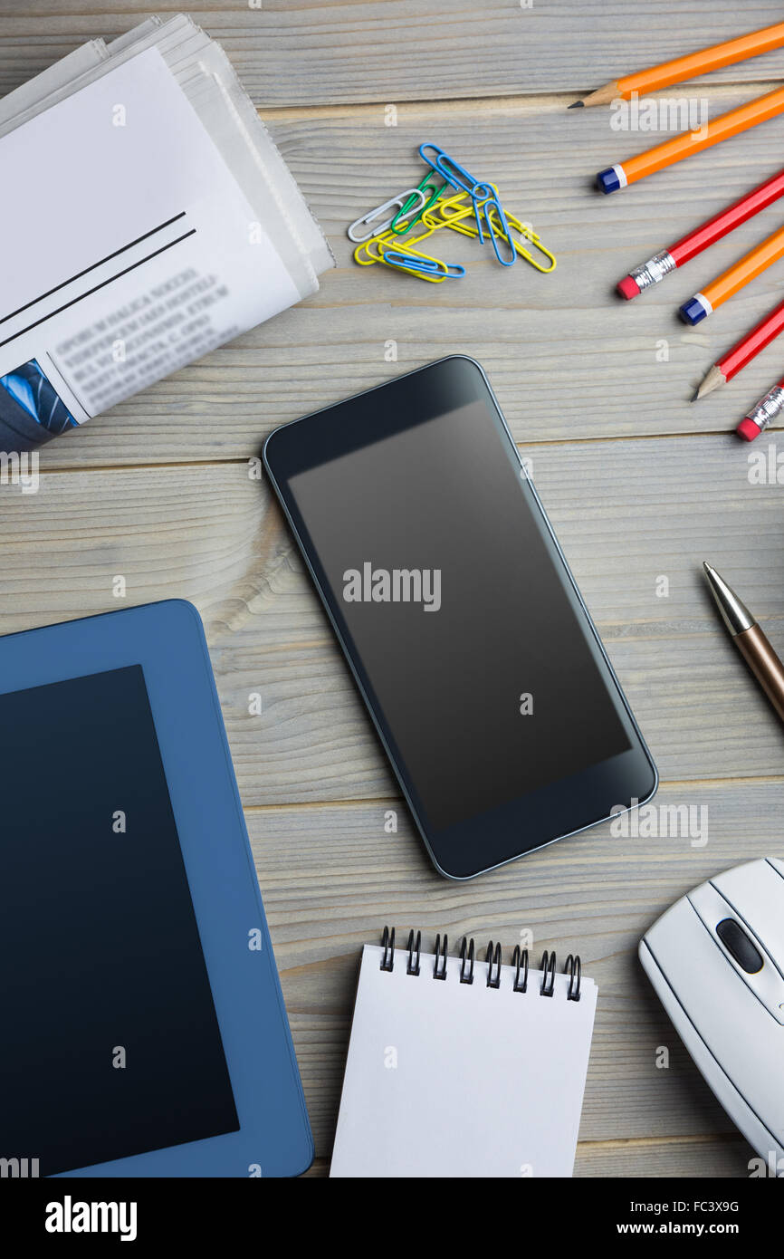 Smartphone next to the newspaper notepad tablet and pen Stock Photo - Alamy