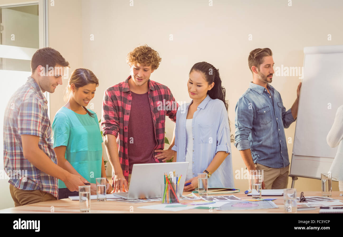 Happy team looking at their work Stock Photo - Alamy