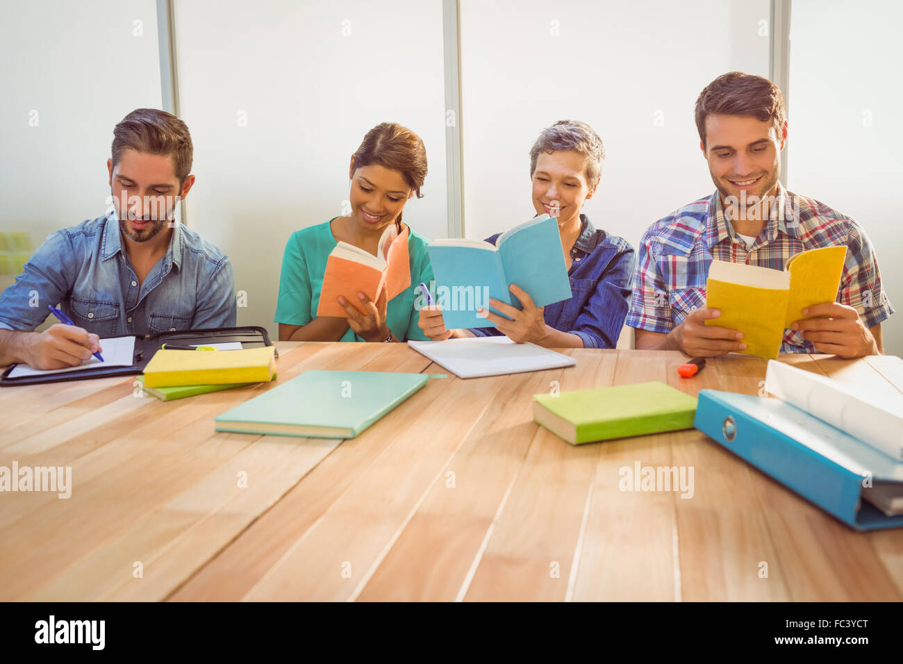 Group of colleagues reading books Stock Photo - Alamy