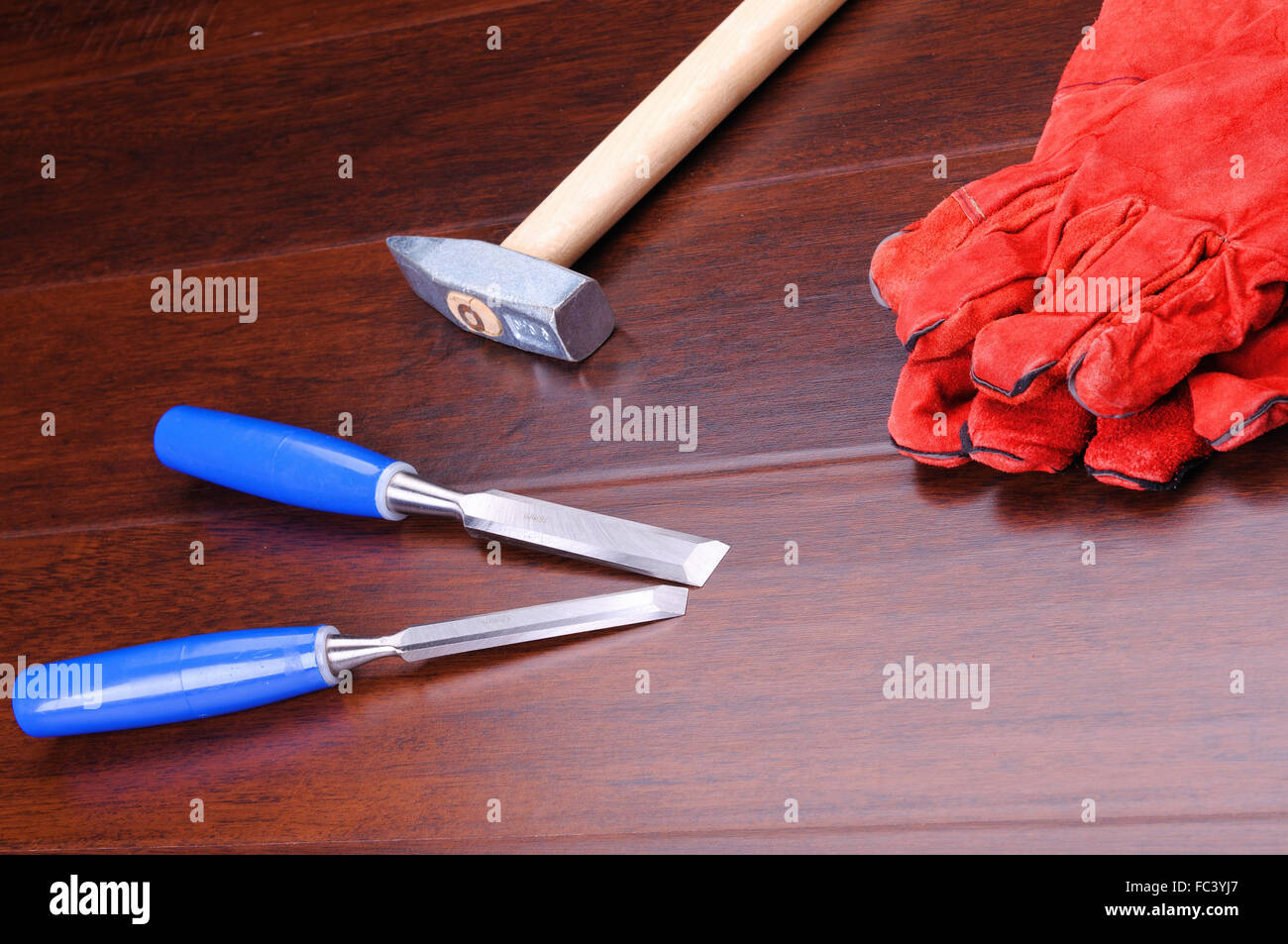 Gloves for working in red and blue tools Stock Photo - Alamy
