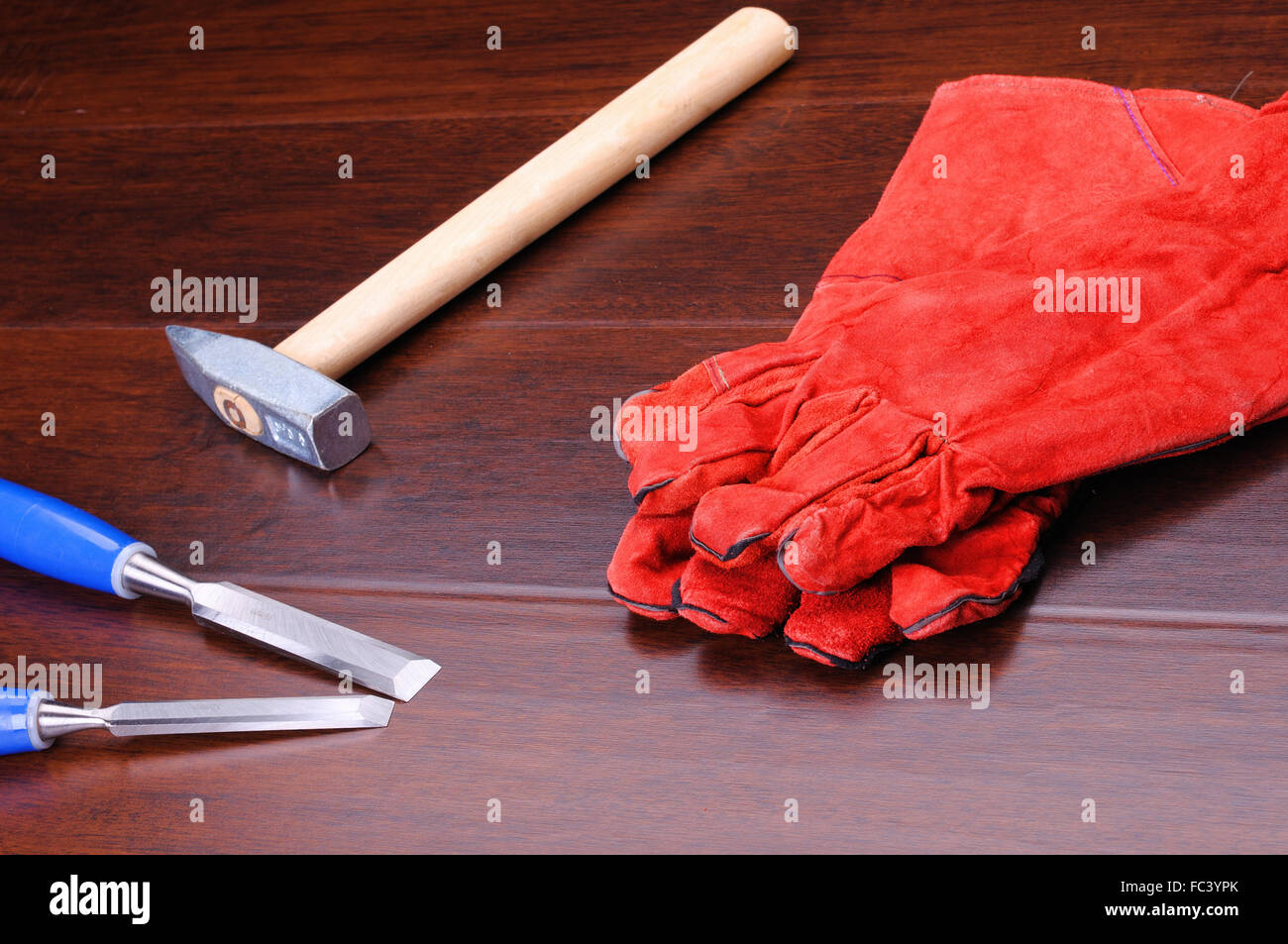 Gloves for working in red and blue tools Stock Photo - Alamy