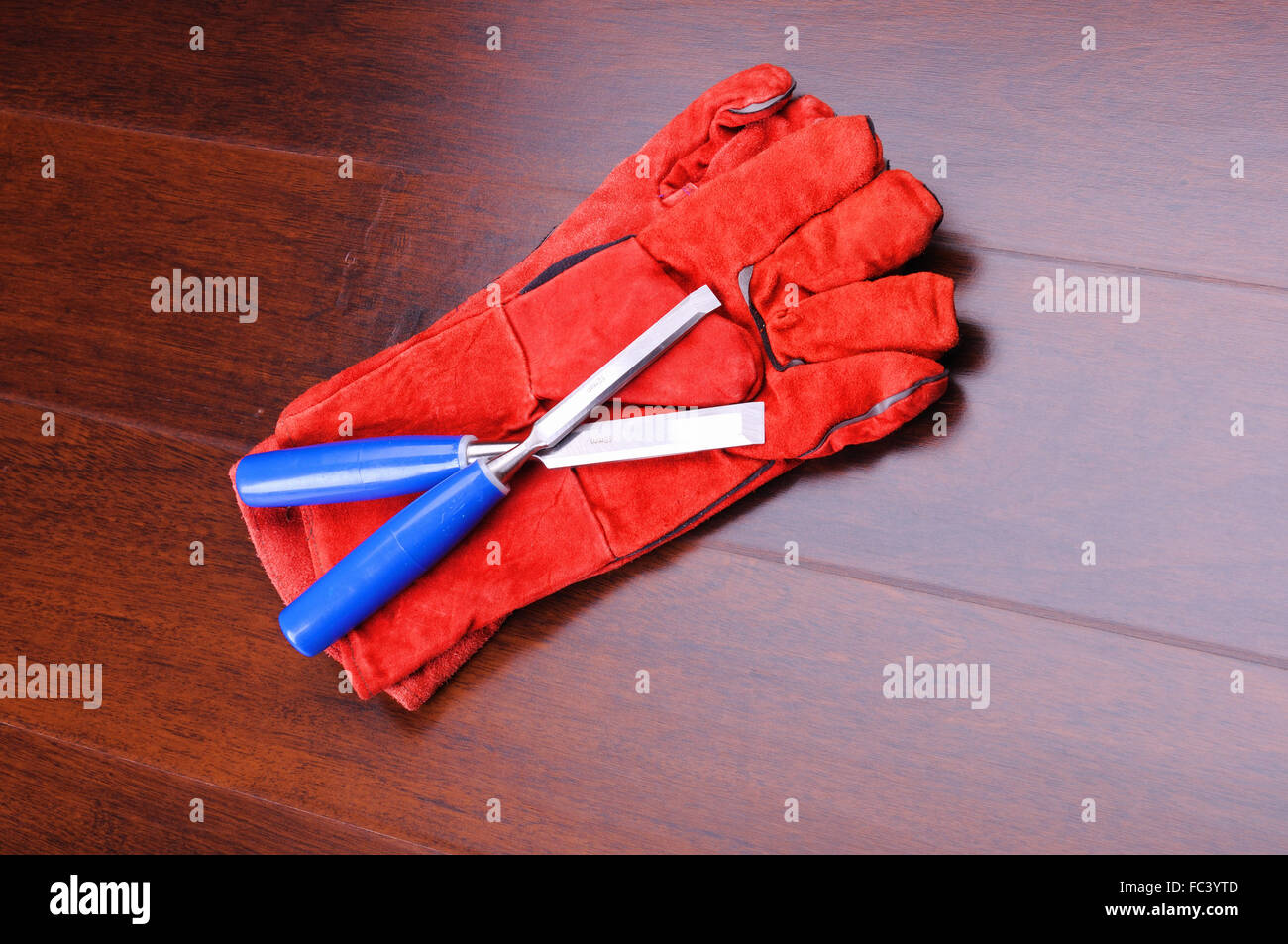 Gloves for working in red and blue tools Stock Photo - Alamy