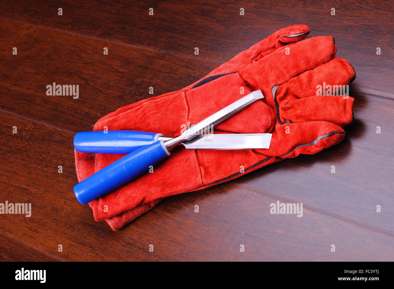 Gloves for working in red and blue tools Stock Photo - Alamy
