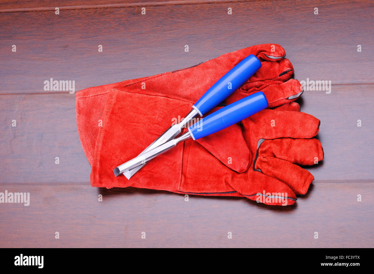 Gloves for working in red and blue tools Stock Photo - Alamy