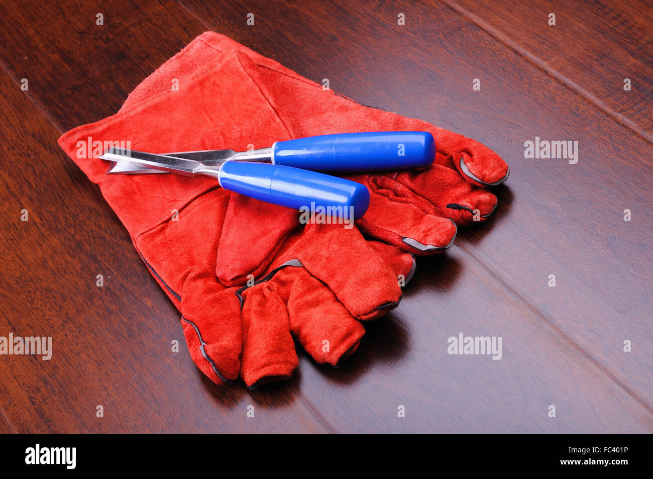Gloves for working in red and blue tools Stock Photo - Alamy