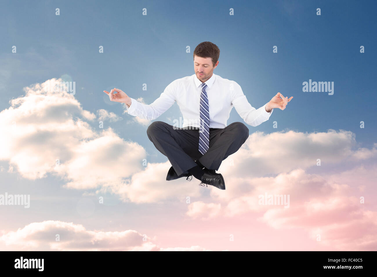 Composite image of businessman in suit sitting in lotus pose Stock ...