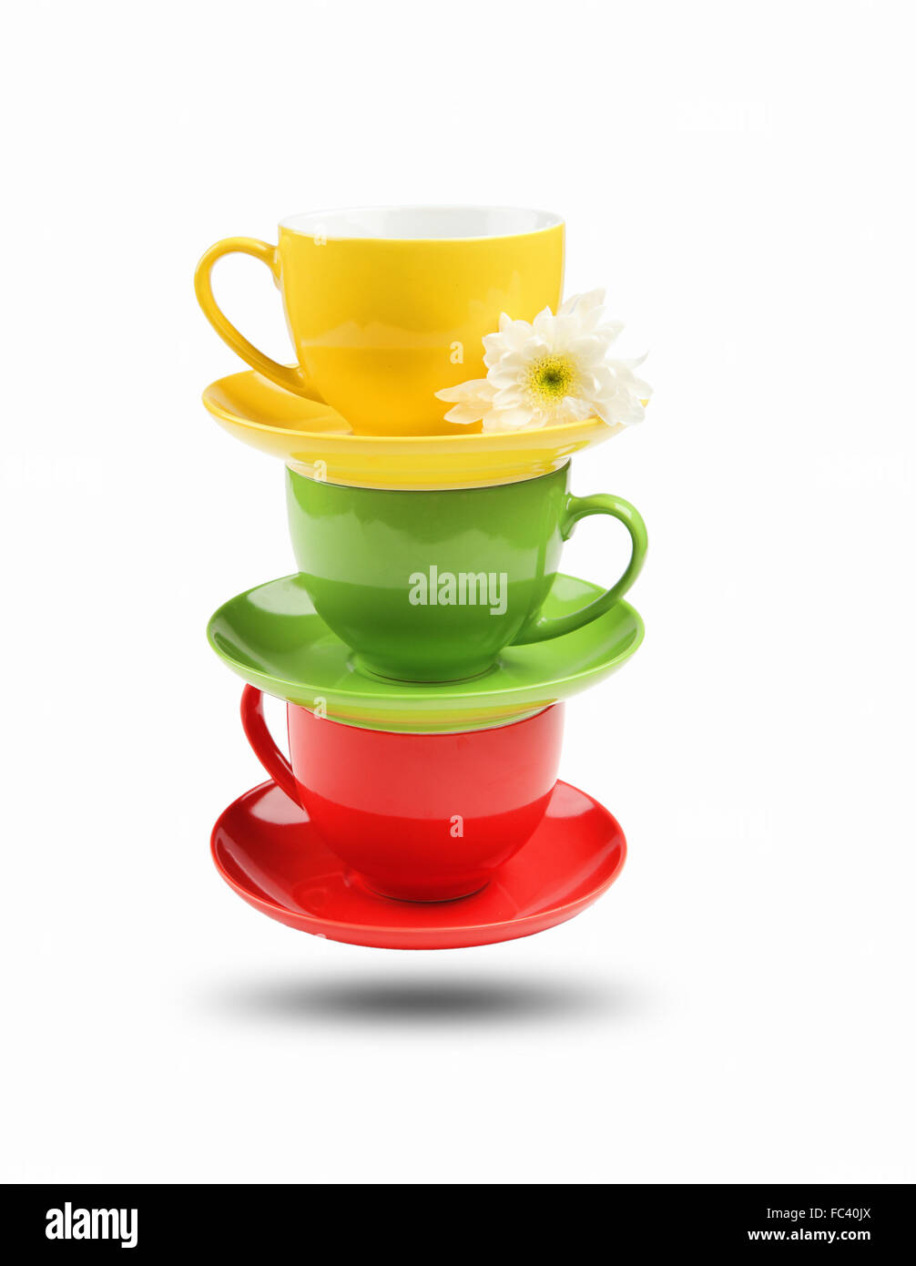 Three different colored cups facing each other on a white background ...