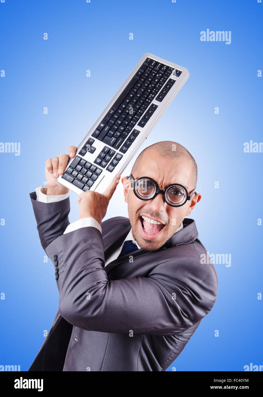 Nerd businessman with computer keyboard against gradient Stock Photo ...