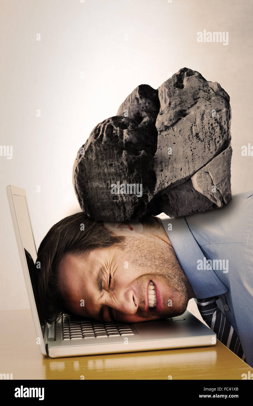 Composite image of businessman resting head on keyboard Stock Photo - Alamy