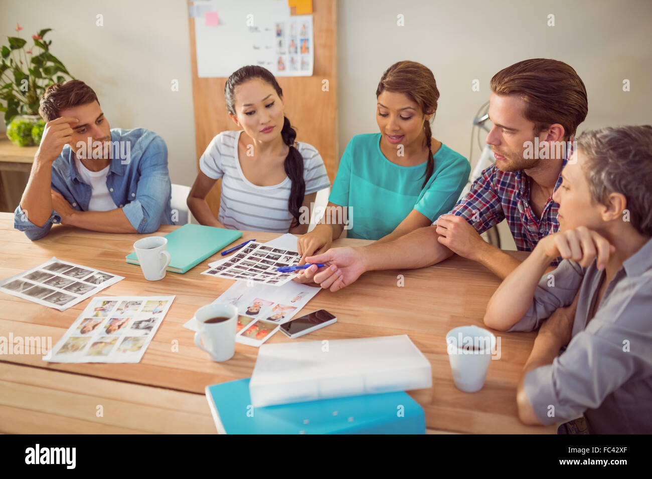 Seated creative business team working together Stock Photo - Alamy