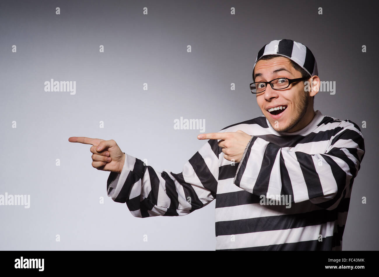 Funny prisoner isolated on gray Stock Photo - Alamy