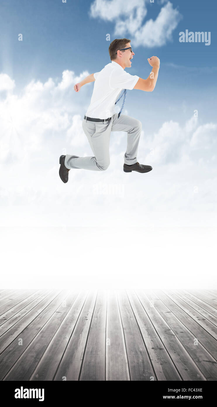 Composite image of geeky happy businessman running mid air Stock Photo ...