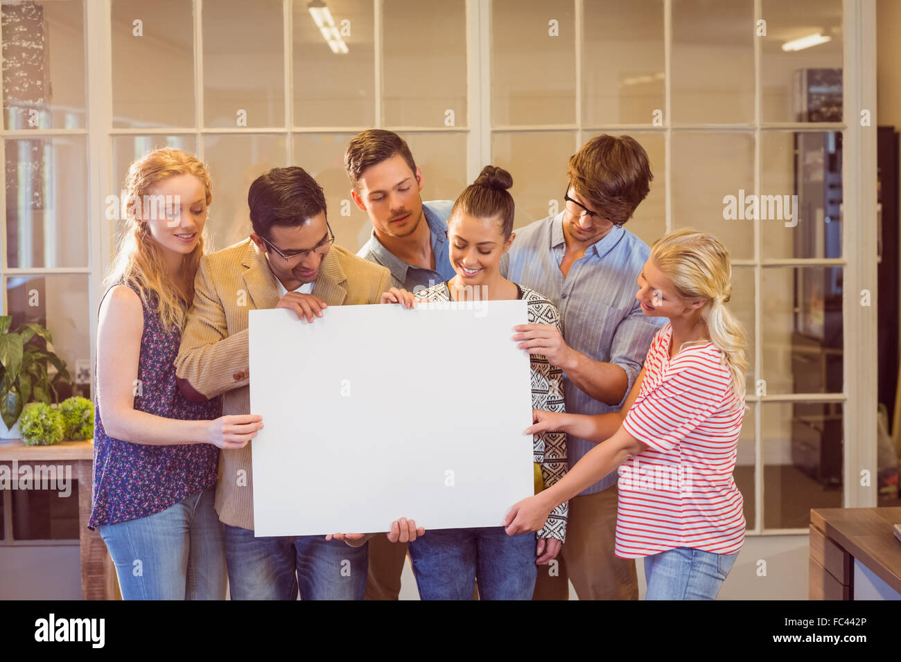 Creative business team holding cardboard written Stock Photo - Alamy