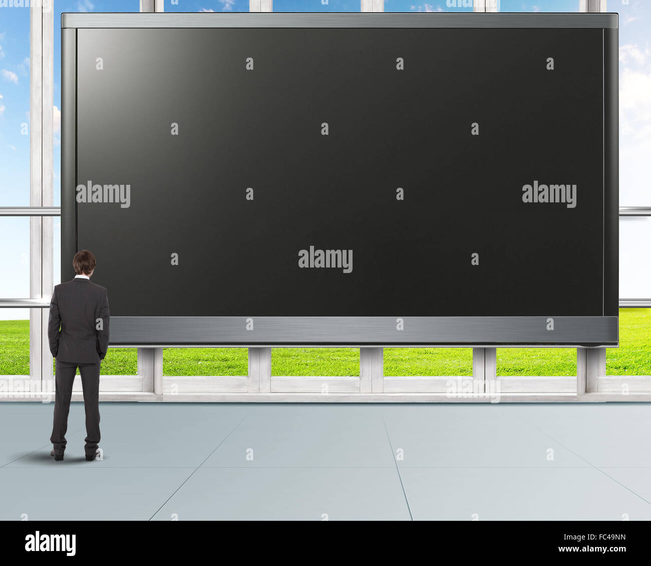 Business person standing near a blank billboard Stock Photo - Alamy