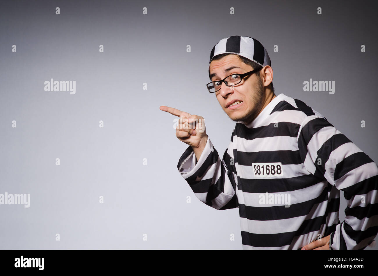Funny prisoner isolated on gray Stock Photo - Alamy