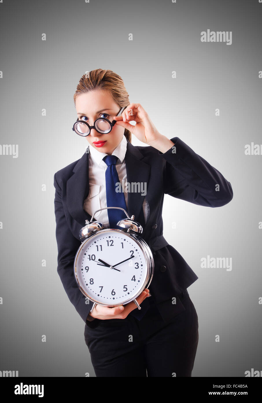 Nerd businesswoman with giant alarm clock Stock Photo - Alamy