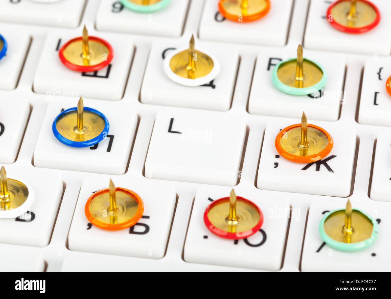 Pins on computer keyboard Stock Photo - Alamy