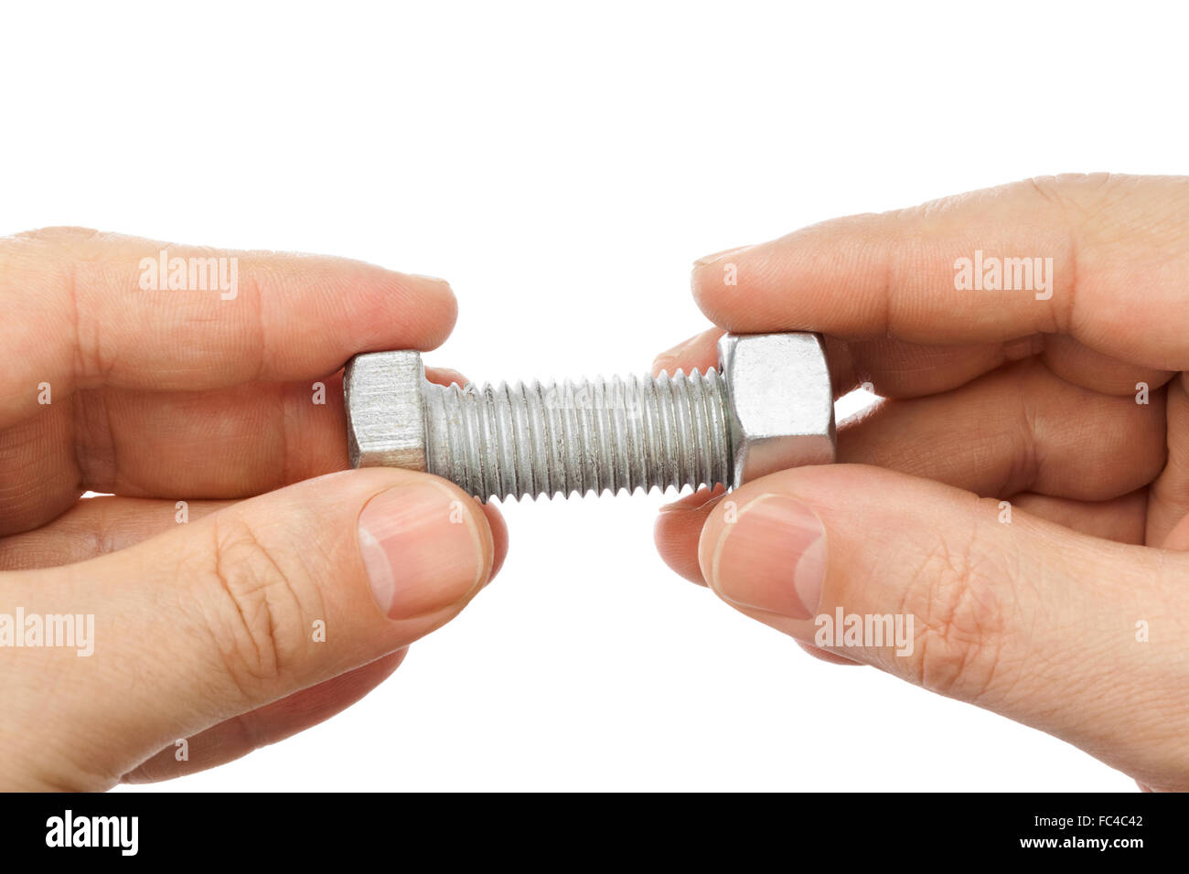 Bolt and nut in hands Stock Photo - Alamy