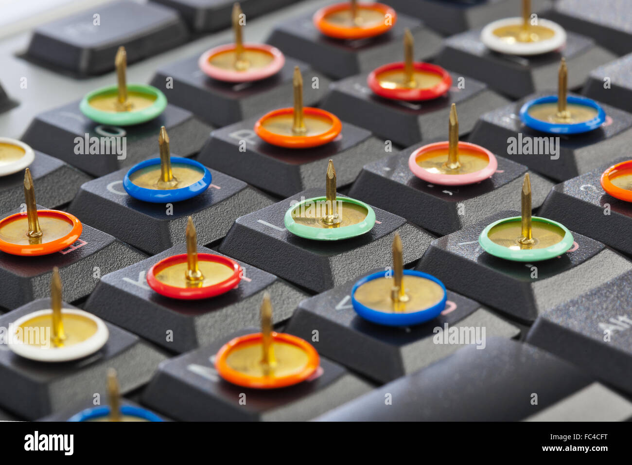 Pins on computer keyboard Stock Photo - Alamy