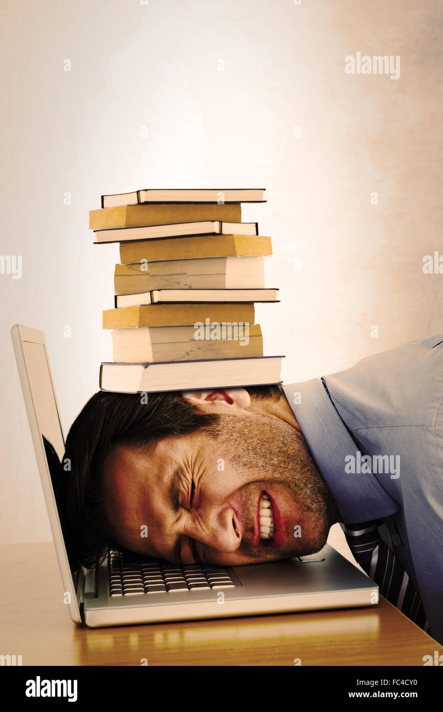 Composite image of businessman resting head on keyboard Stock Photo - Alamy