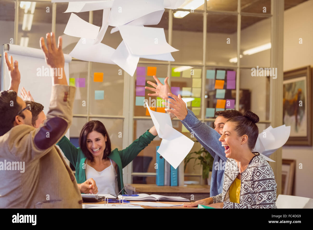 Celebrating business people throwing papers in the air Stock Photo - Alamy