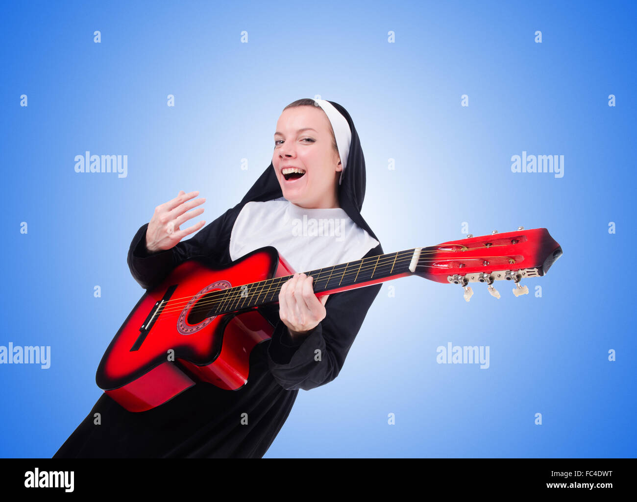 Nun playing guitar against the gradient Stock Photo - Alamy