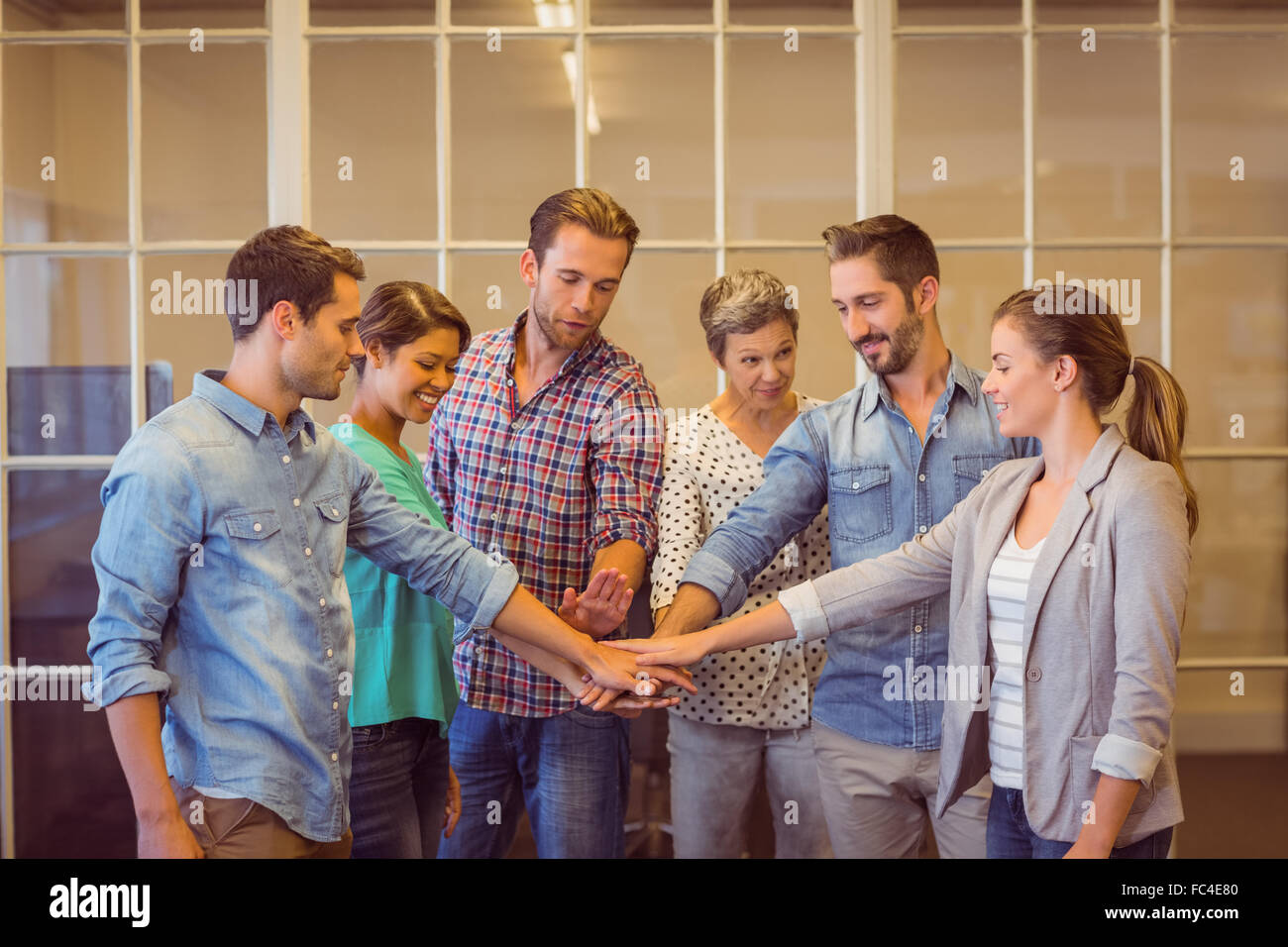 Creative business team putting their hands together Stock Photo - Alamy