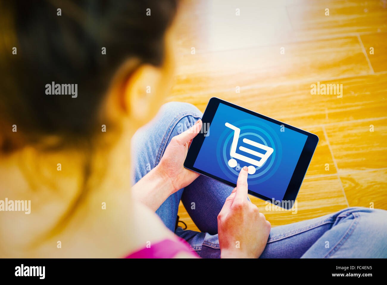 Composite image of woman using tablet at home Stock Photo - Alamy