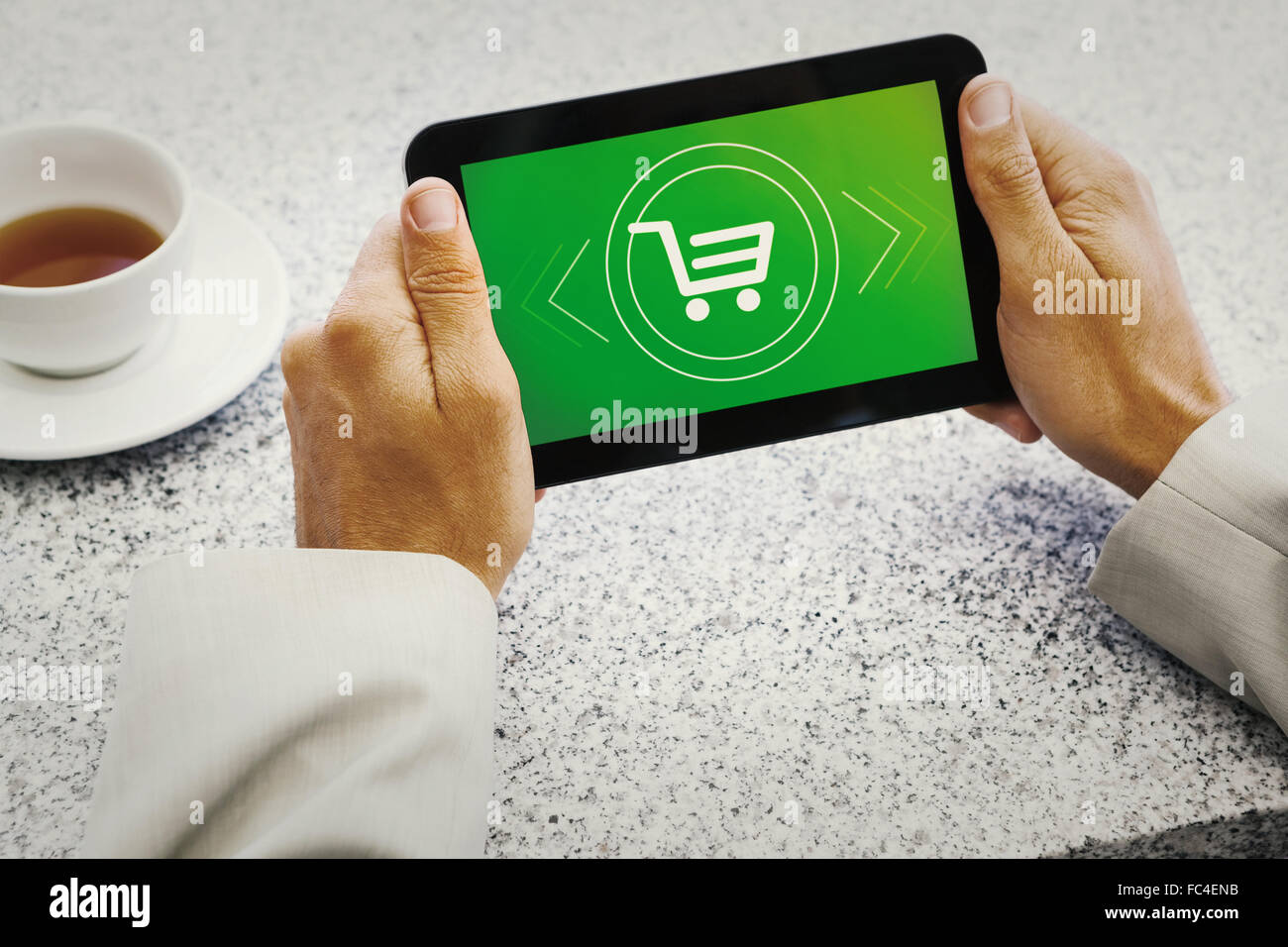 Composite image of businessman holding small tablet at table Stock ...