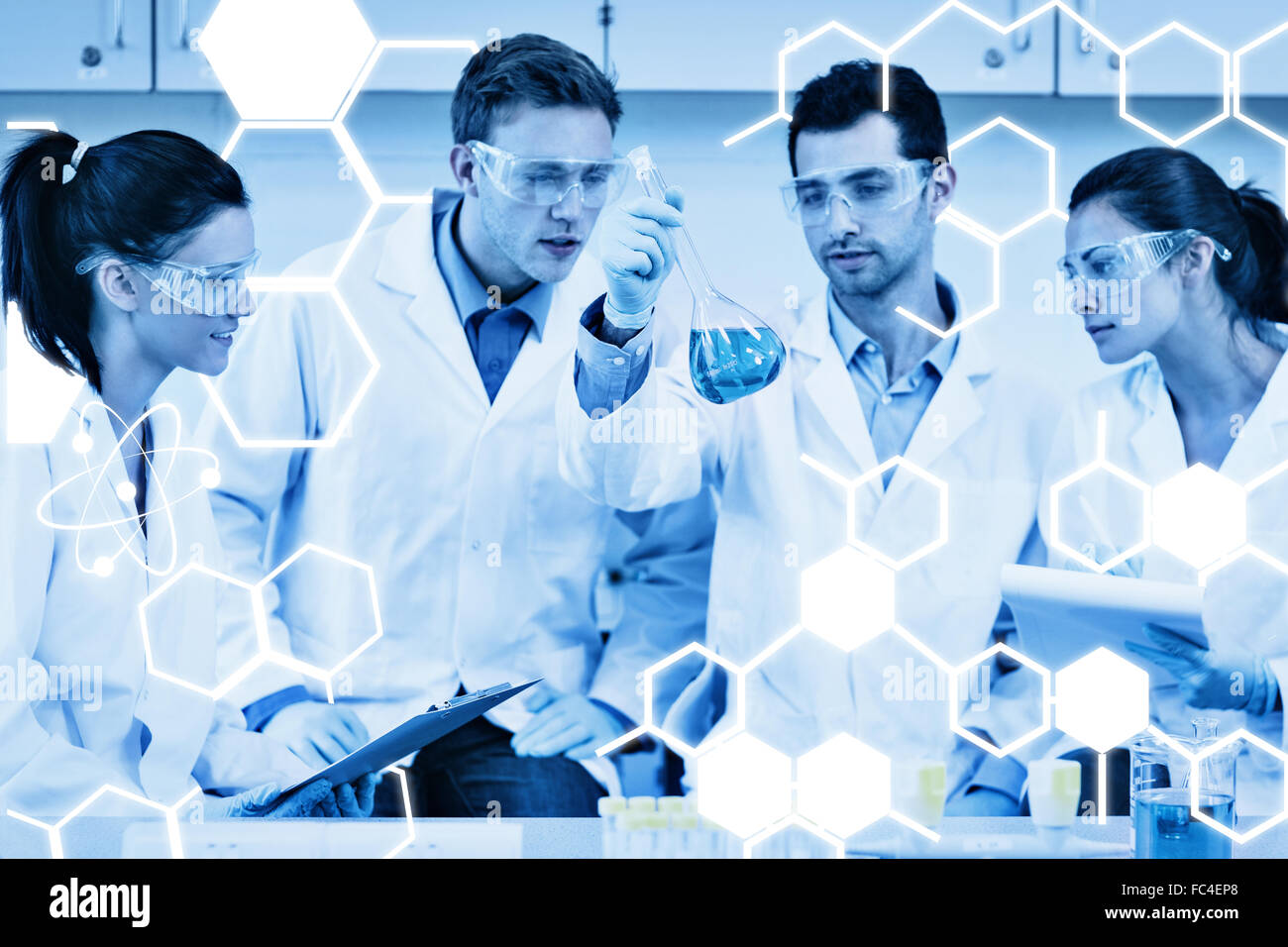 Composite image of scientists working on an experiment at the ...
